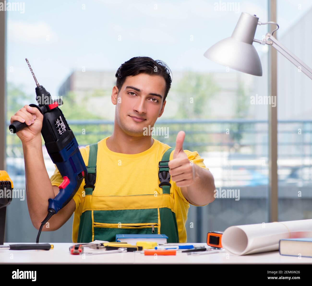 The construction worker sitting at the desk Stock Photo - Alamy