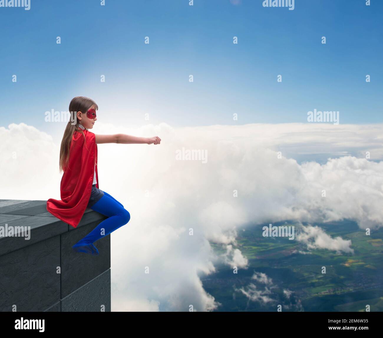The young girl in superhero costume overlooking the city Stock Photo ...