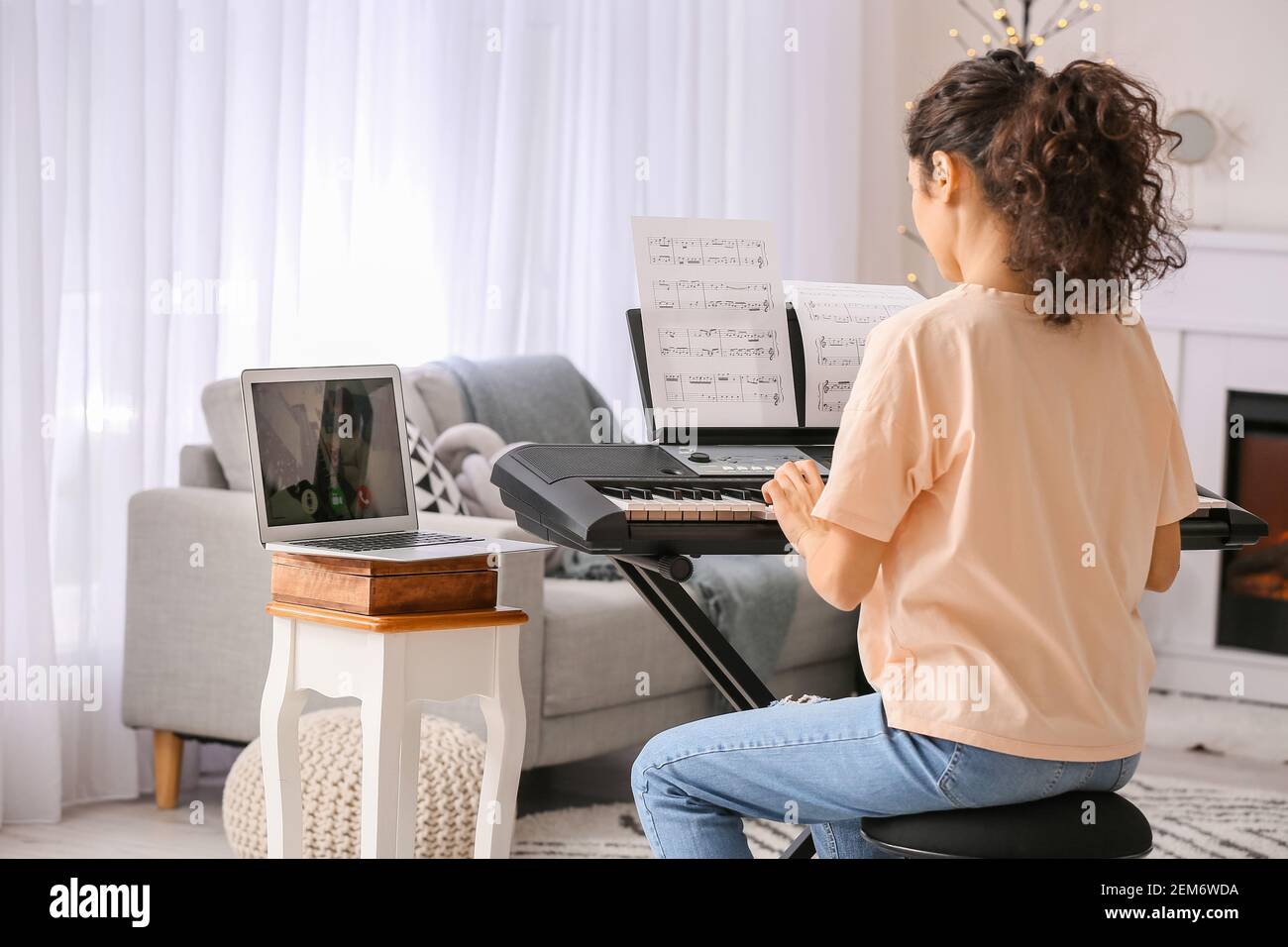 Young woman giving music lessons online at home Stock Photo - Alamy