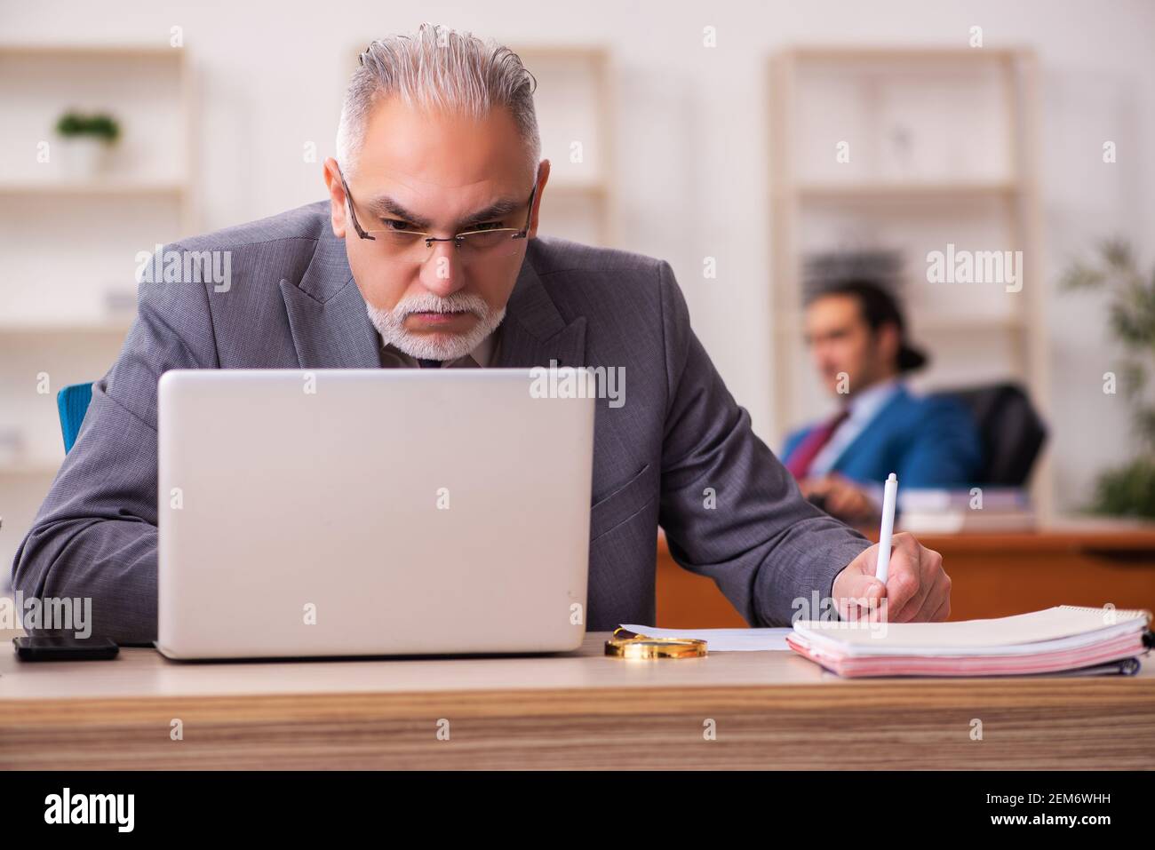 Two male employees working in the office Stock Photo - Alamy