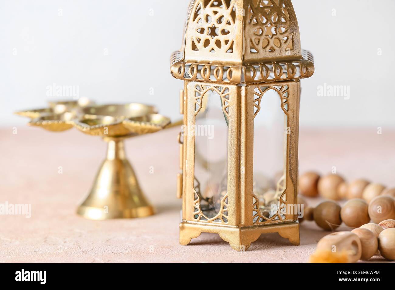 Muslim lamp and tasbih on light background Stock Photo - Alamy