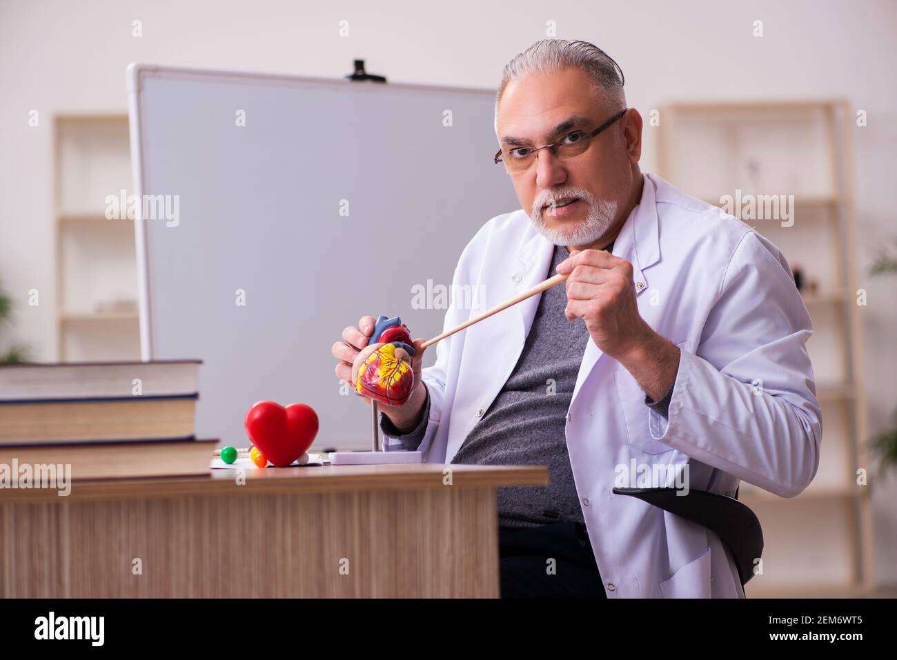 Old doctor cardiologist sitting in the classroom Stock Photo - Alamy