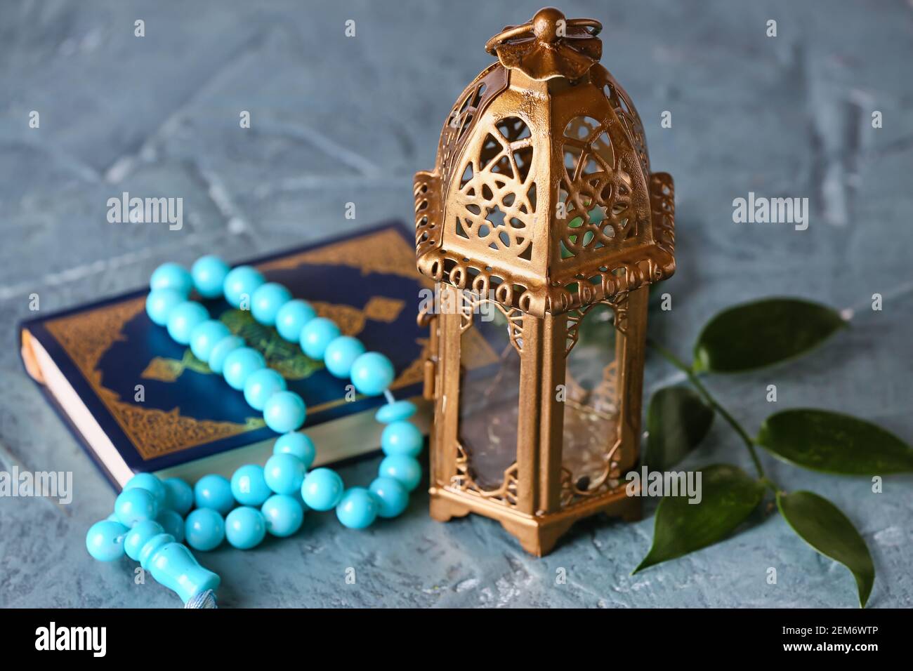 Muslim lamp, tasbih and Koran on color background Stock Photo - Alamy