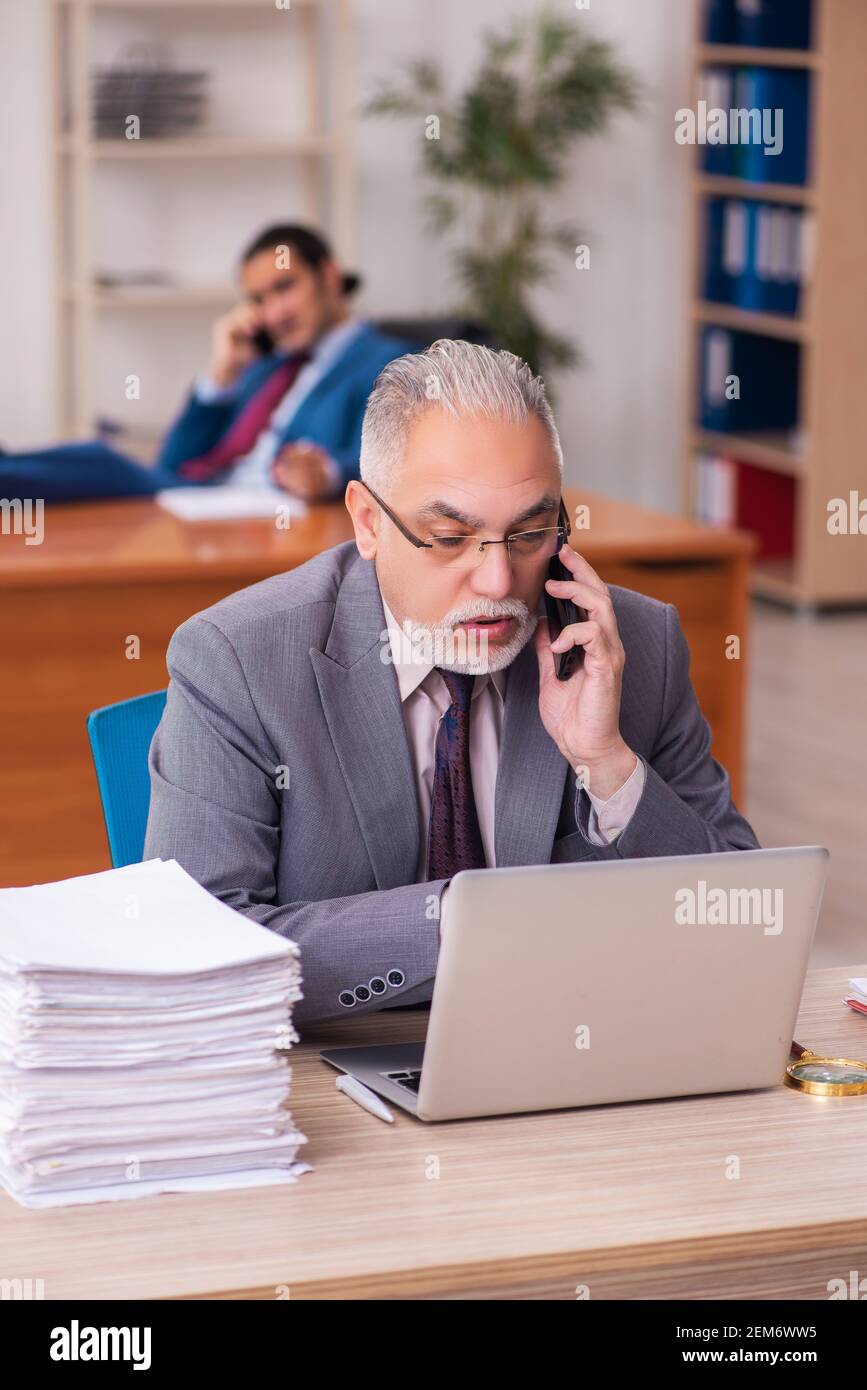 Two male employees working in the office Stock Photo - Alamy