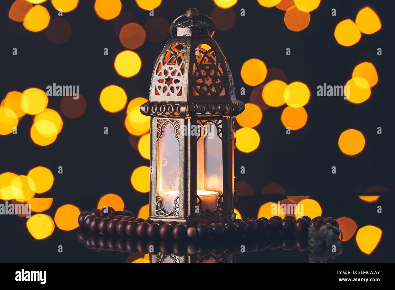 Muslim lamp and tasbih on dark background with blurred lights Stock ...