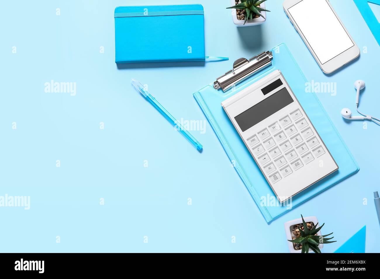 Modern calculator and stationery with mobile phone on color background ...