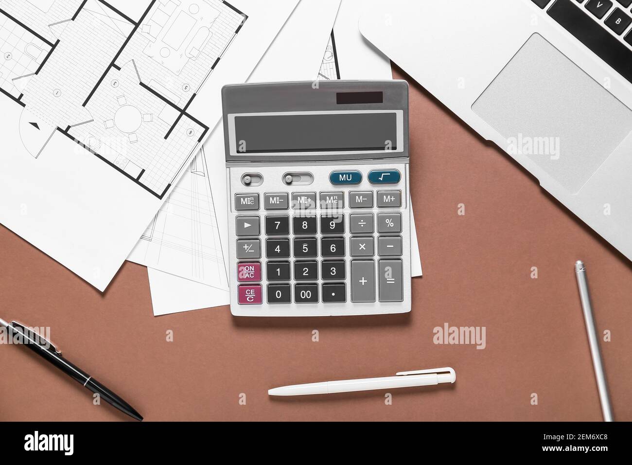 Modern calculator with house plans and laptop on color background Stock ...