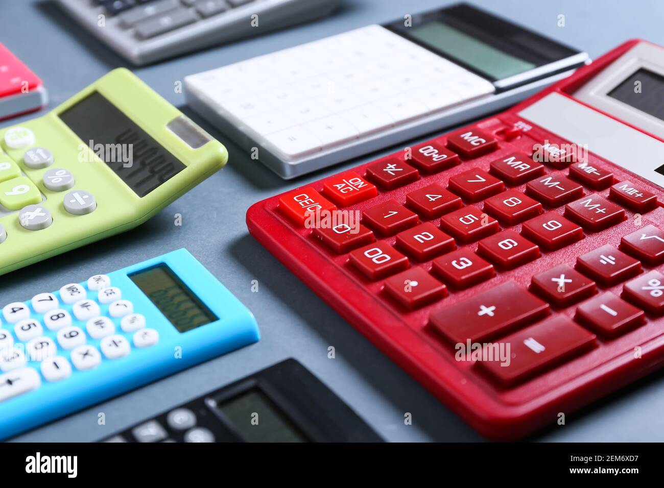 Modern calculators on grey background Stock Photo - Alamy