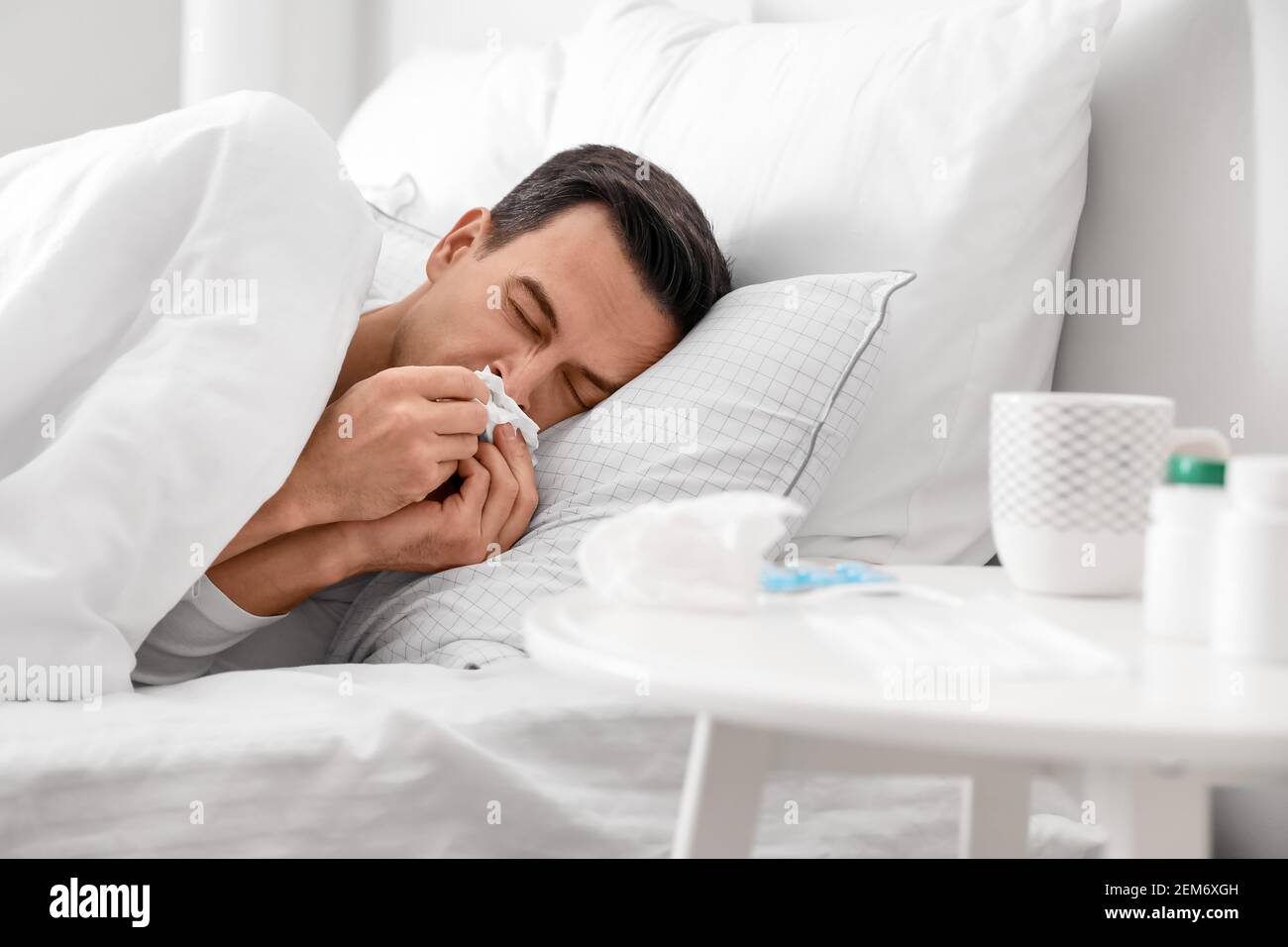Sick man in bed at home Stock Photo - Alamy