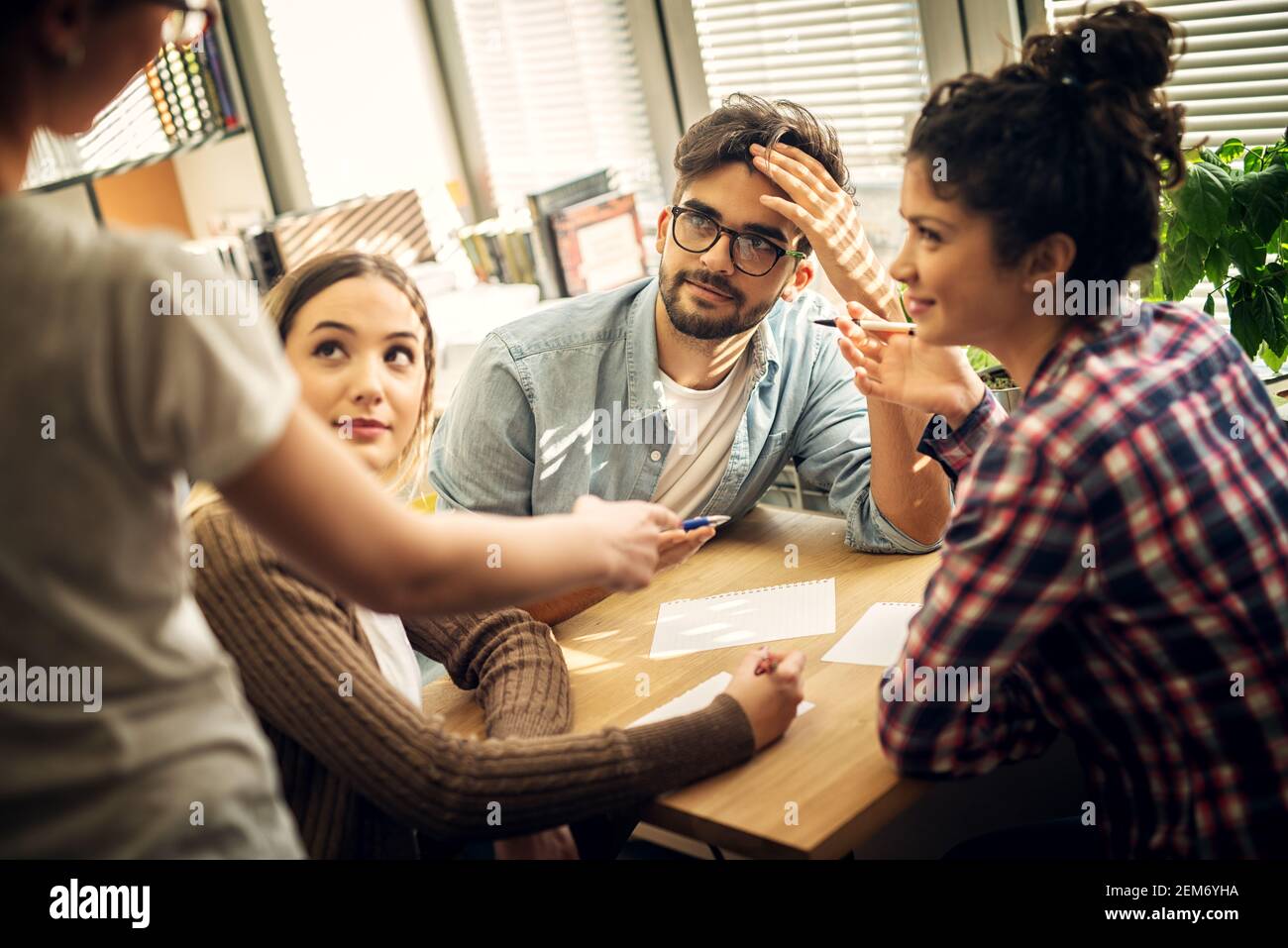 A professor is giving an assignment to a group of young cheerful ...