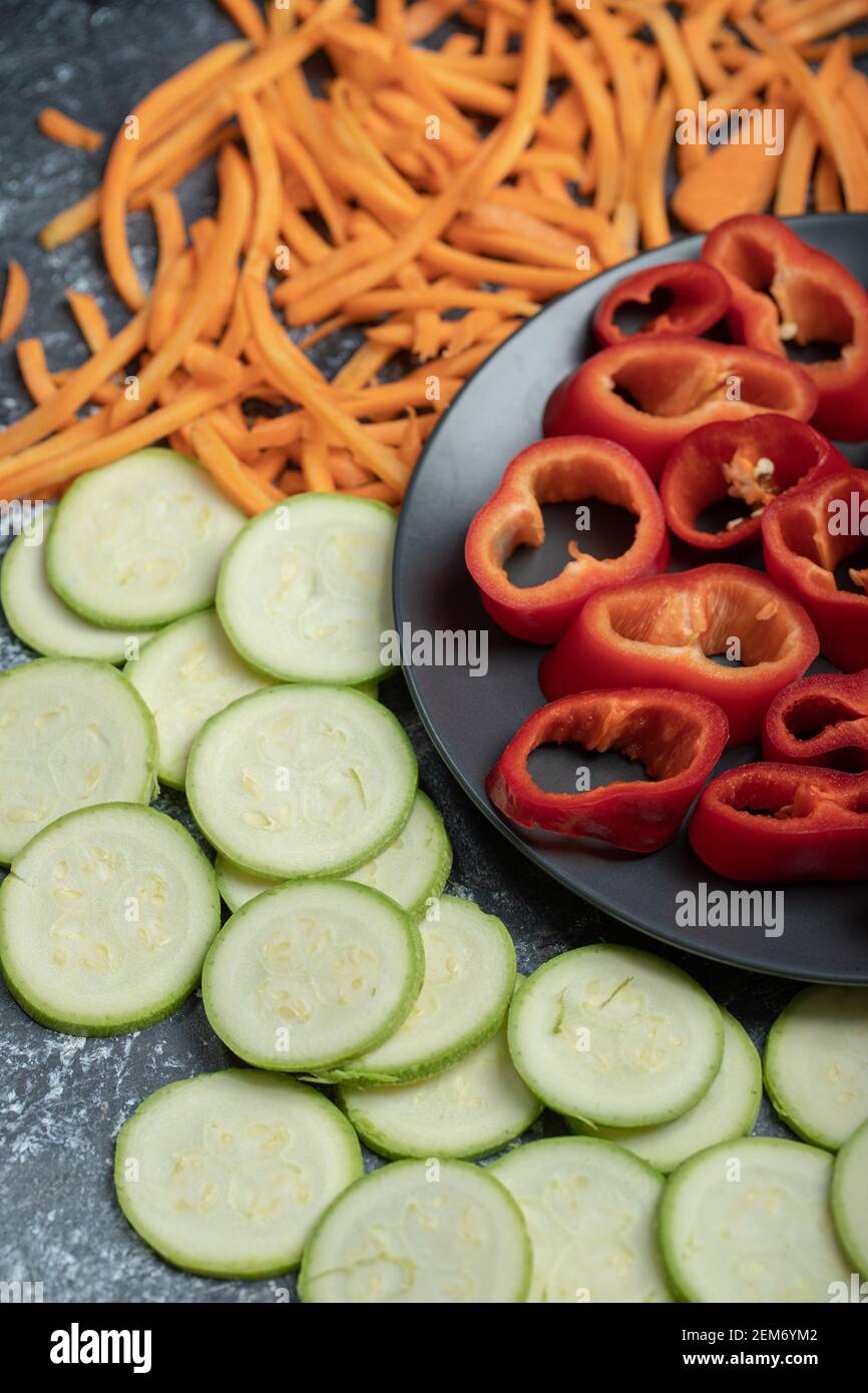 Variety of sliced vegetables on marble background Stock Photo - Alamy