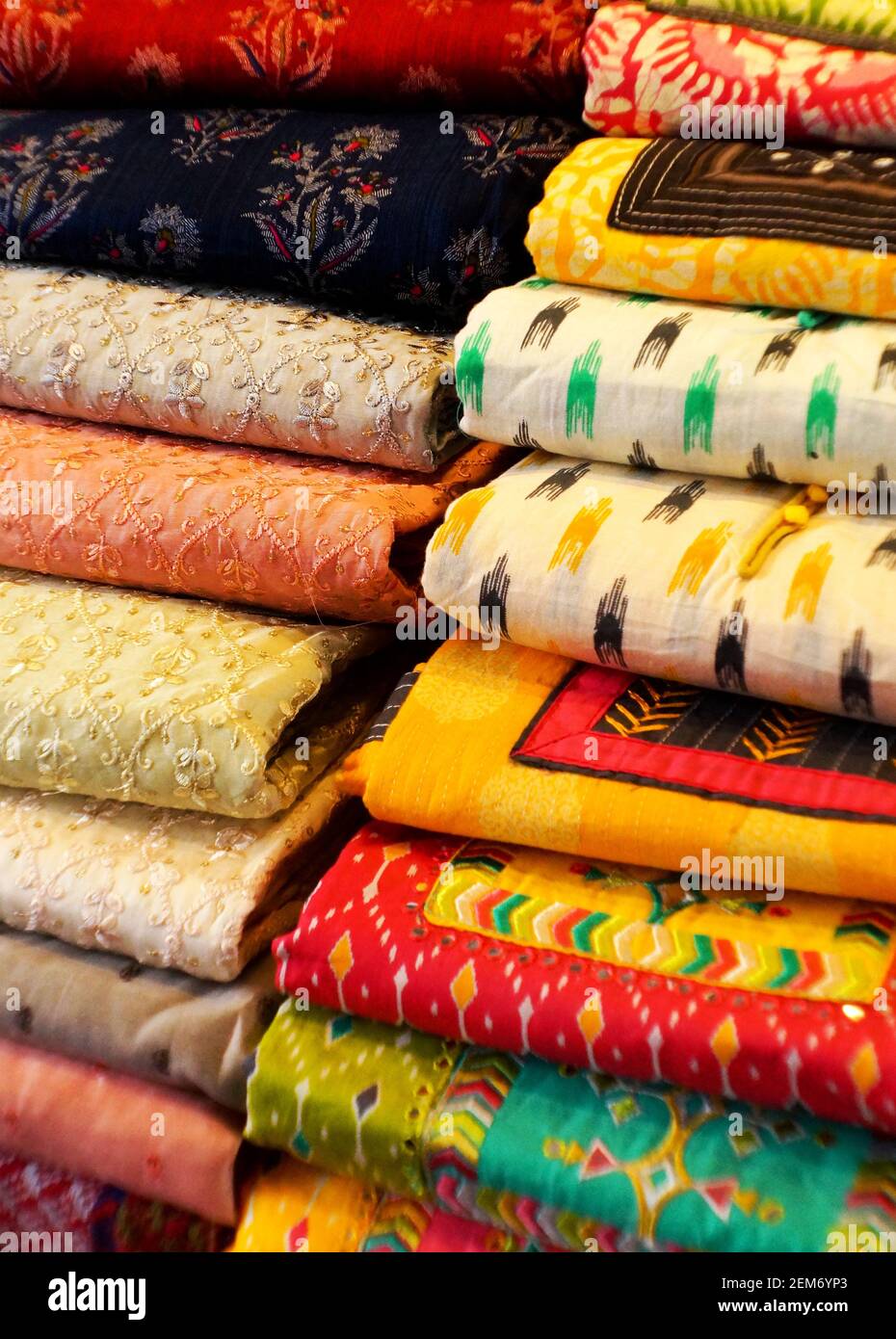 Close-up view of Indian woman wear sarees or saris stacked retail shop ...