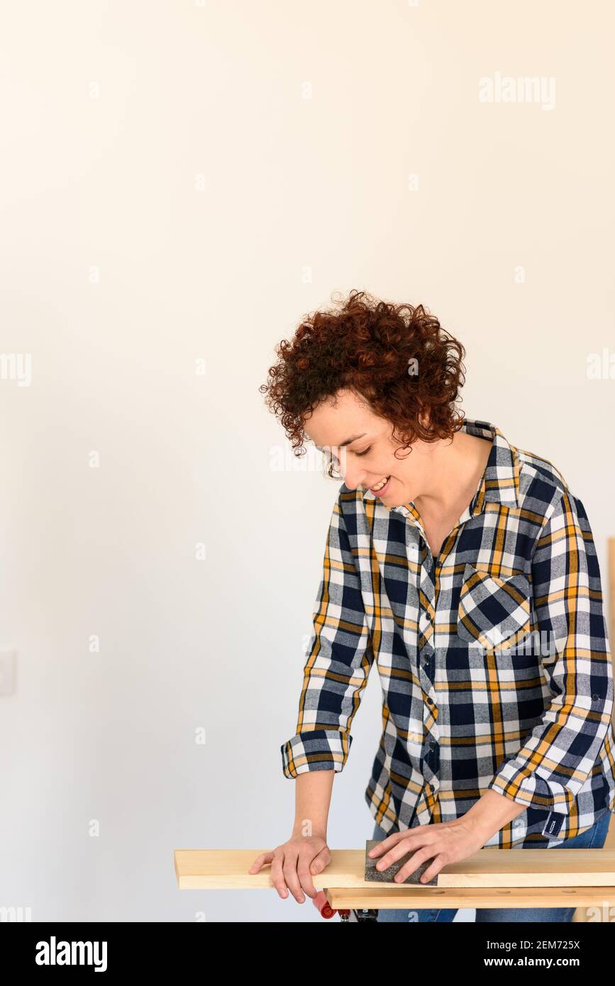 Girl doing DIY and handicraft tasks, dressed in a plaid shirt and jeans ...