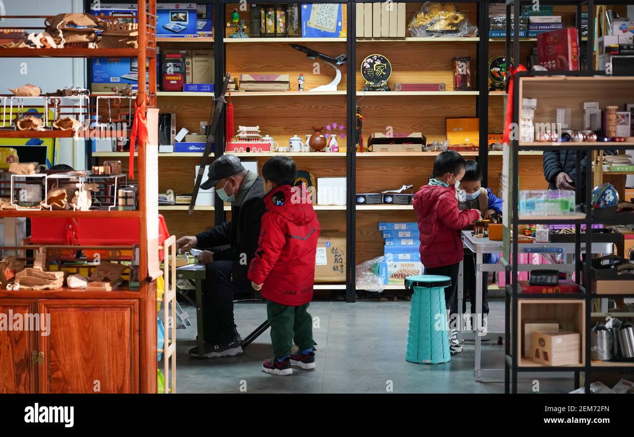 Beijing, China. 23rd Feb, 2021. Customers and their children play at a ...