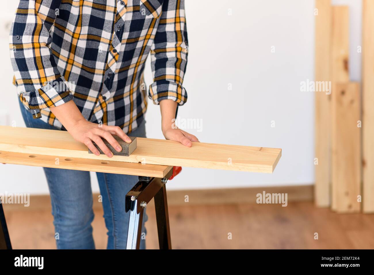 Girl doing DIY and handicraft tasks, dressed in a plaid shirt and jeans ...