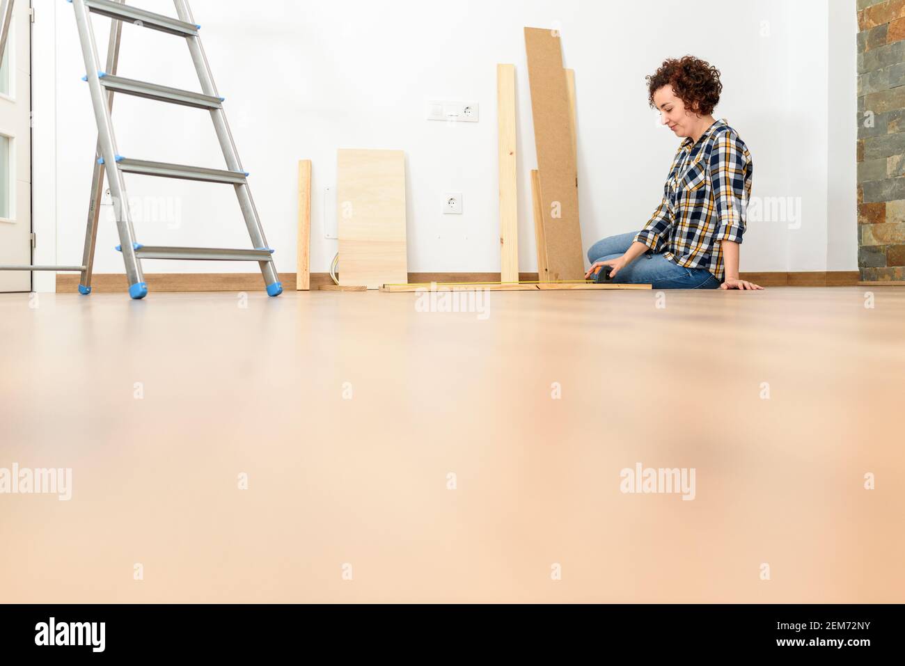 Young person doing DIY work at home. Photography at ground level ...