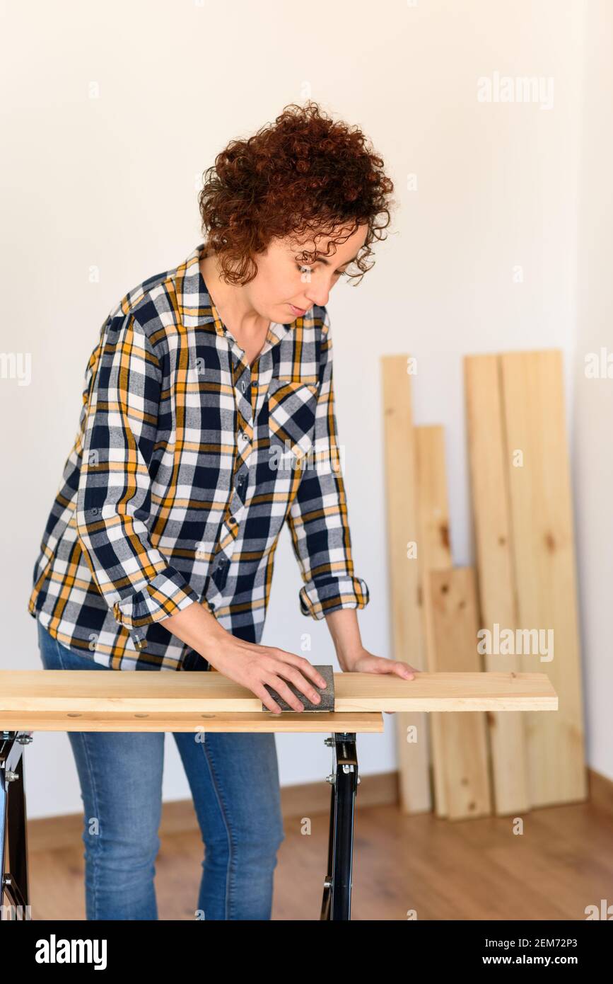 Girl doing DIY and handicraft tasks, dressed in a plaid shirt and jeans ...