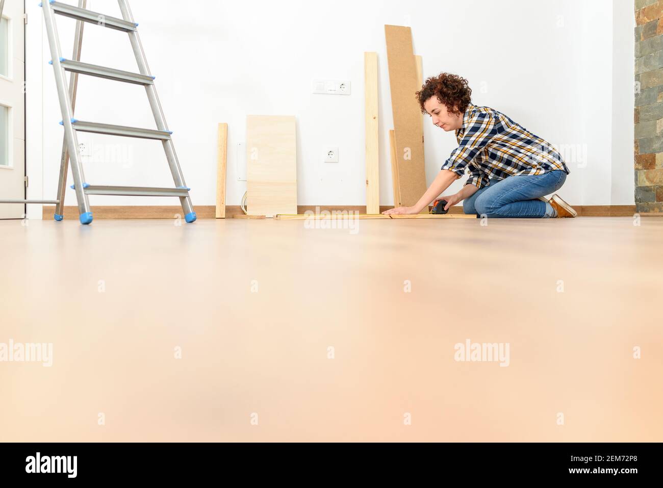 Young person doing DIY work at home. Photography at ground level ...