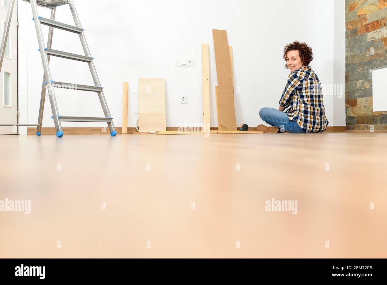 Young person doing DIY work at home. Photography at ground level ...