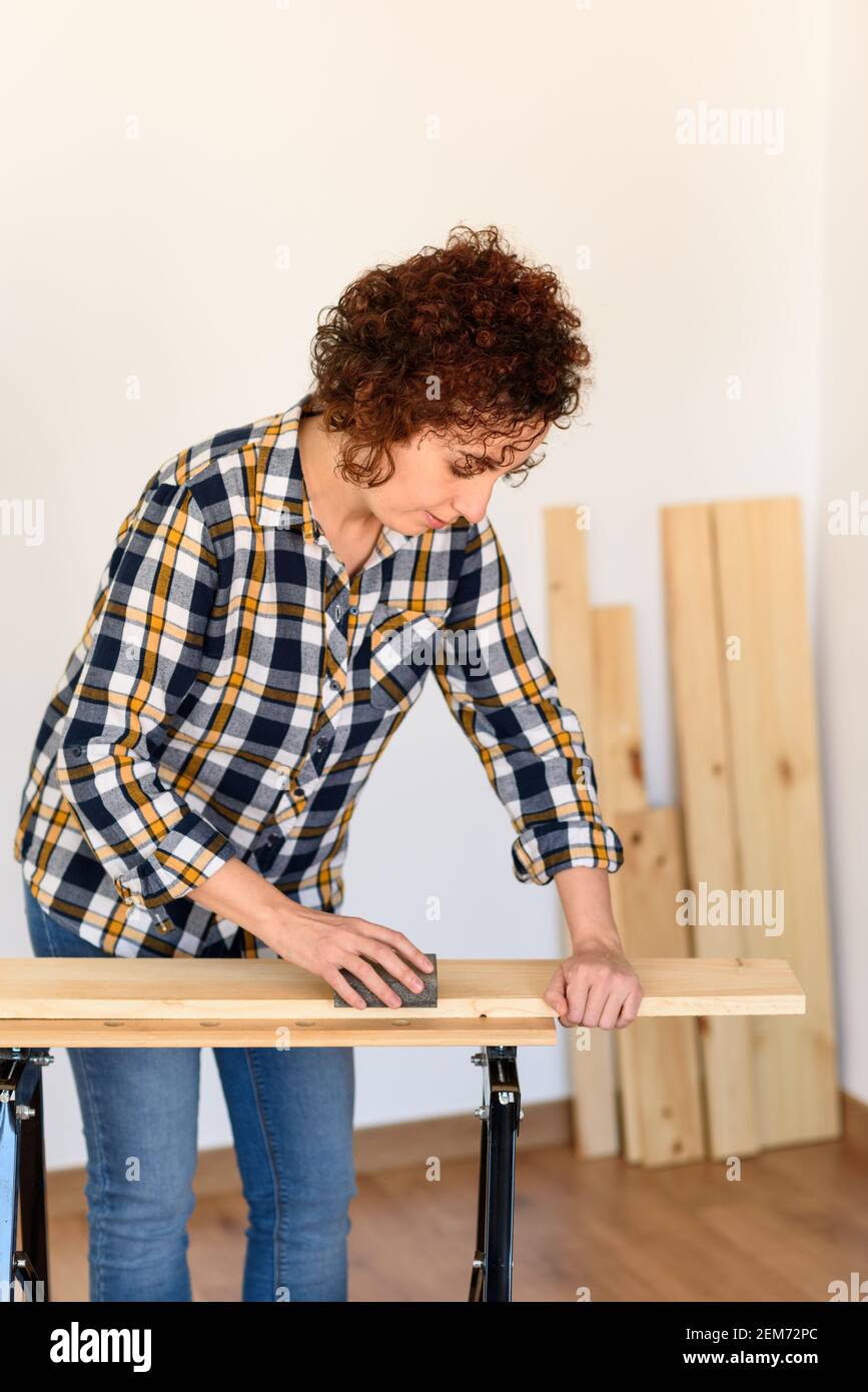 Girl doing DIY and handicraft tasks, dressed in a plaid shirt and jeans ...