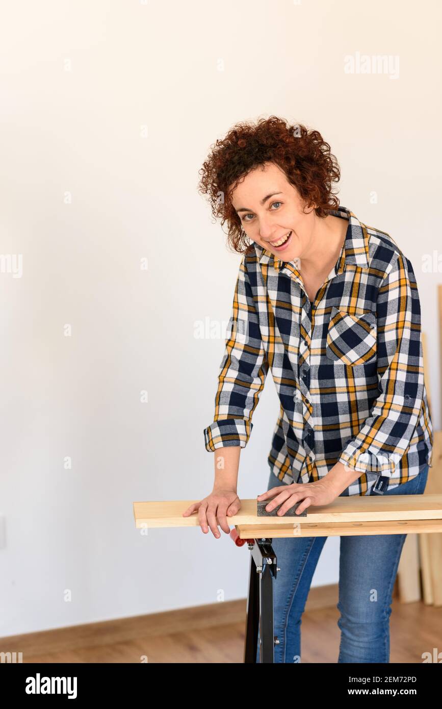 Girl doing DIY and handicraft tasks, dressed in a plaid shirt and jeans ...