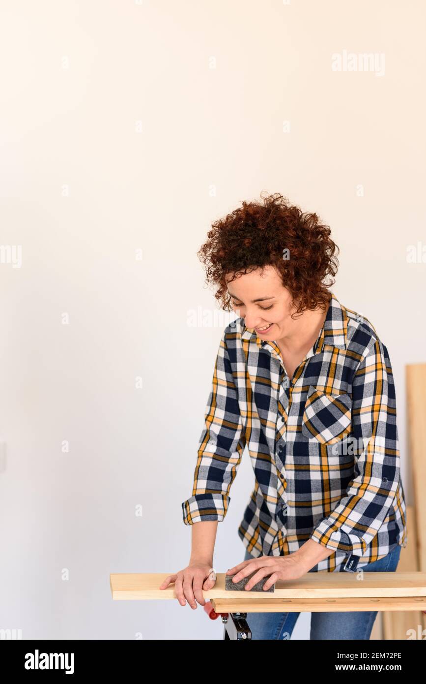 Girl doing DIY and handicraft tasks, dressed in a plaid shirt and jeans ...