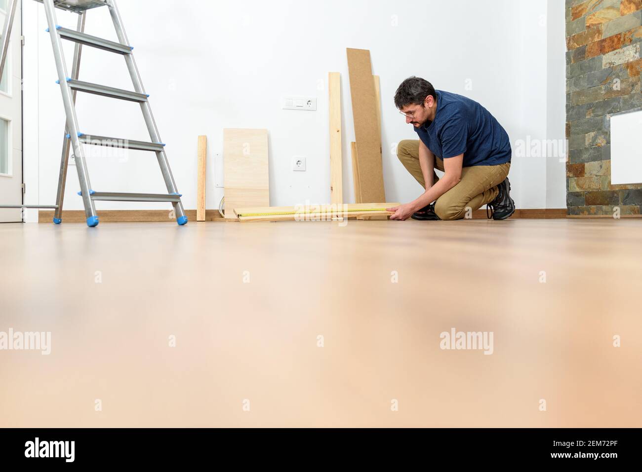 Young person doing DIY work at home. Photography at ground level ...