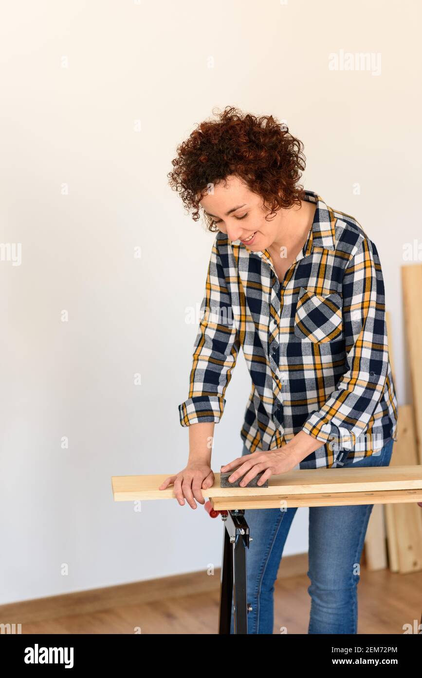 Girl doing DIY and handicraft tasks, dressed in a plaid shirt and jeans ...