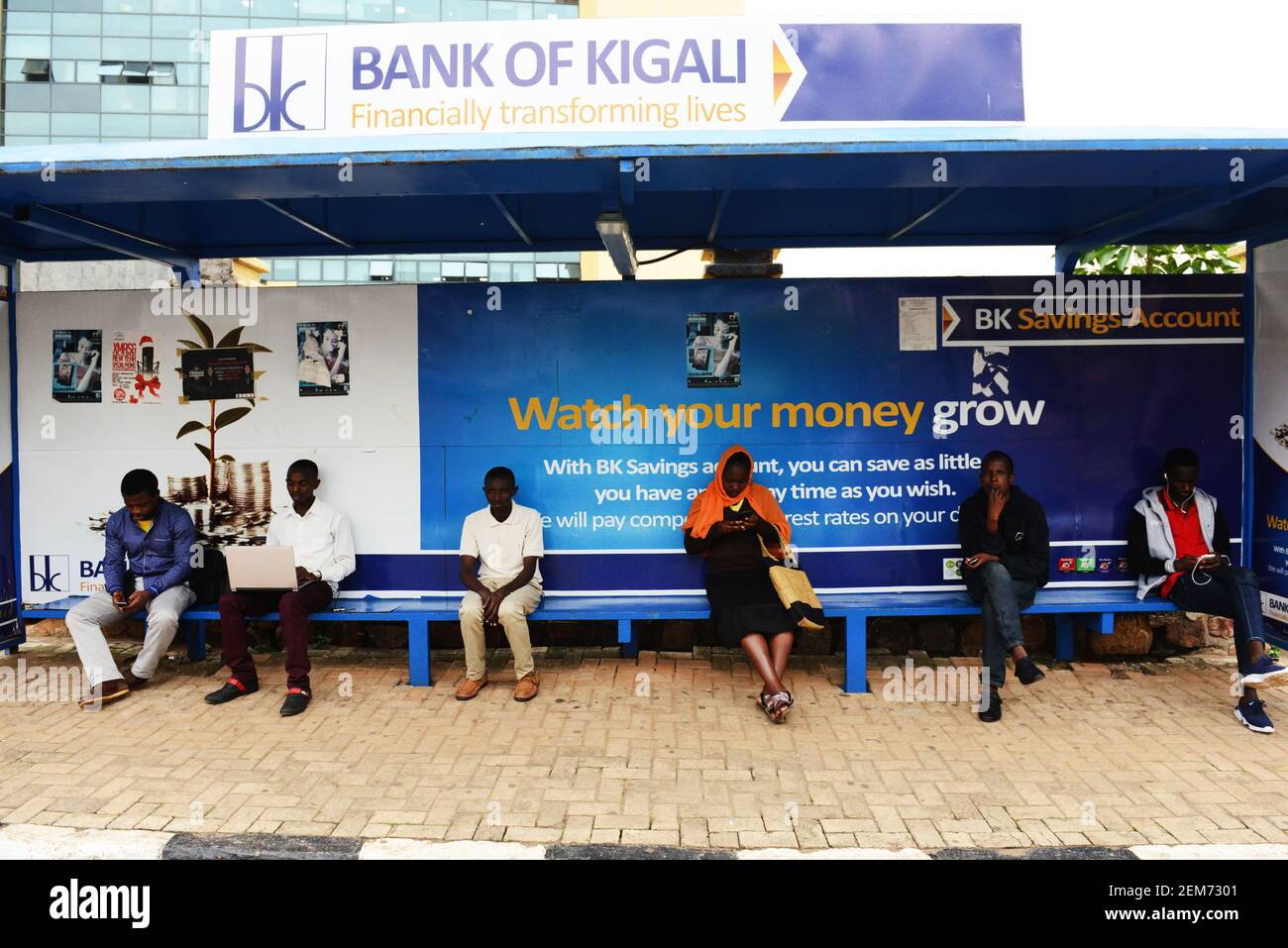 Rwandans waiting at a bus stop in Kigali, Rwanda Stock Photo - Alamy