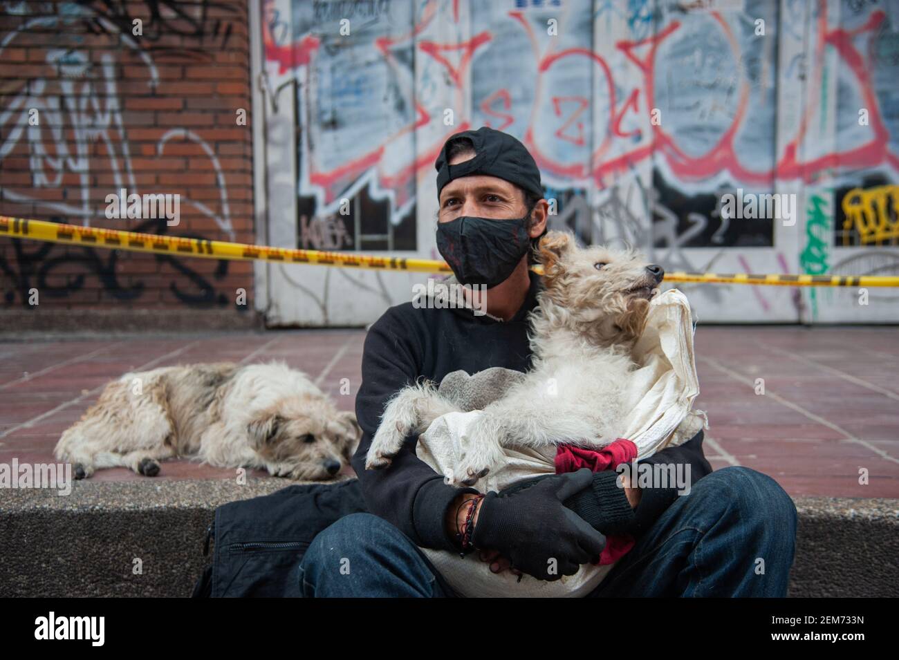 A men with hs dogs is seen during anti-police demonstrations ...