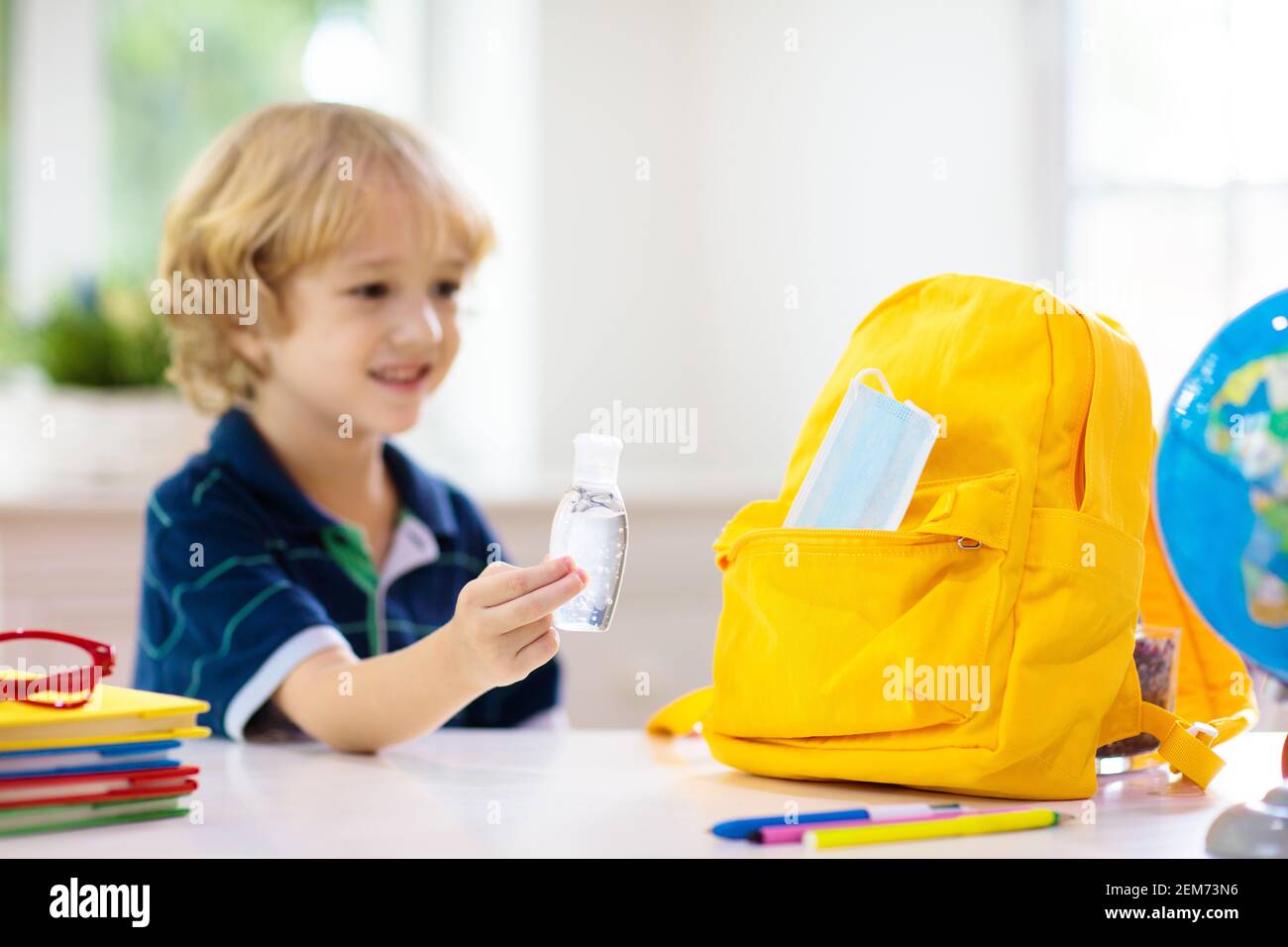 School child with backpack, face mask and sanitizer. Student safety ...