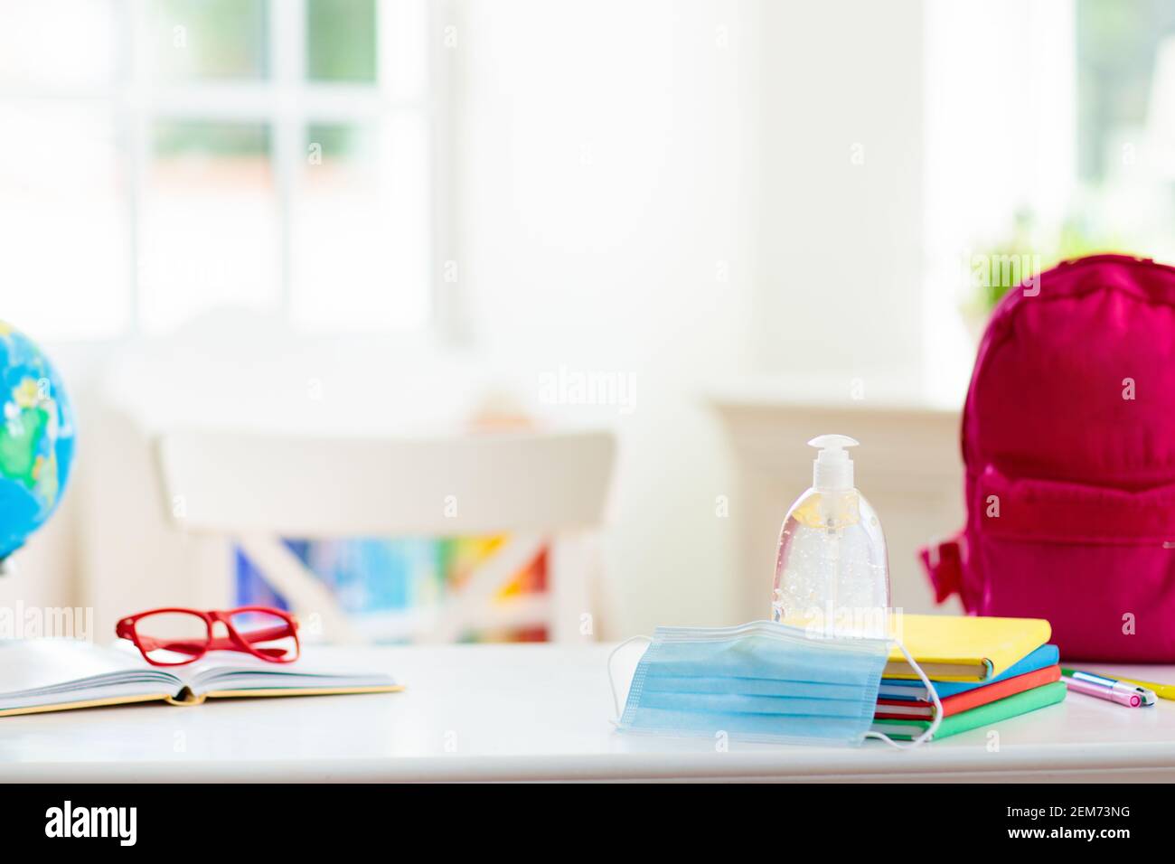 Backpack of school child with face mask and sanitizer. Student safety ...