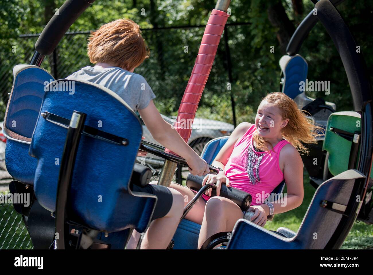 St. Paul, Minnesota. 13 and 11 year old siblings having fun on an ...