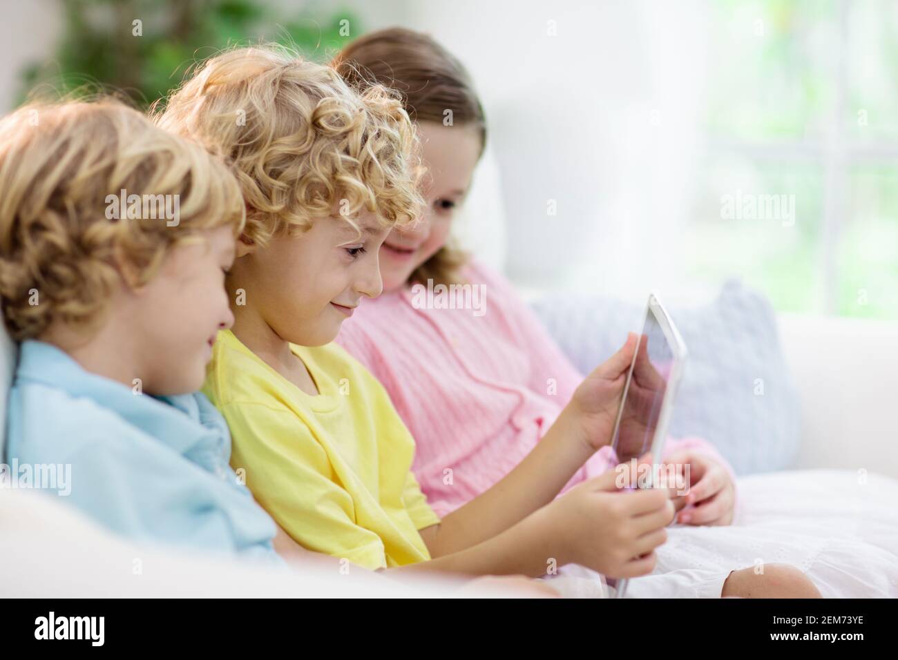 Kids with mobile phone. Child with tablet computer watching movie or ...