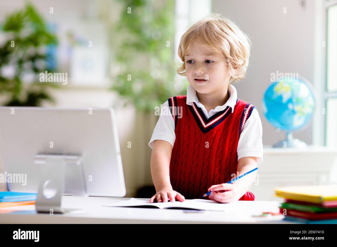 Online remote learning. School kids with computer having video ...