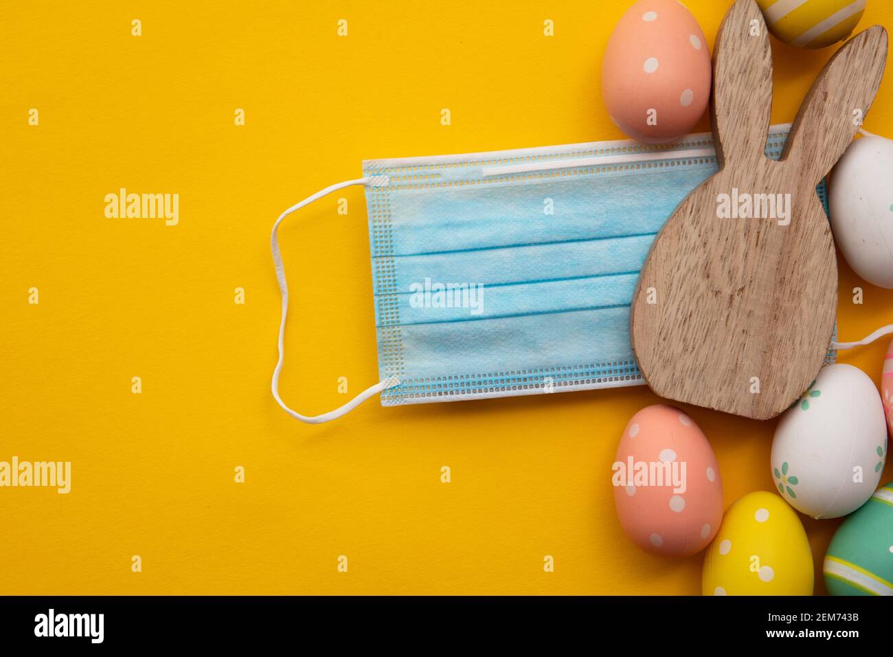 Happy easter background with easter bunny and eggs during covid ...