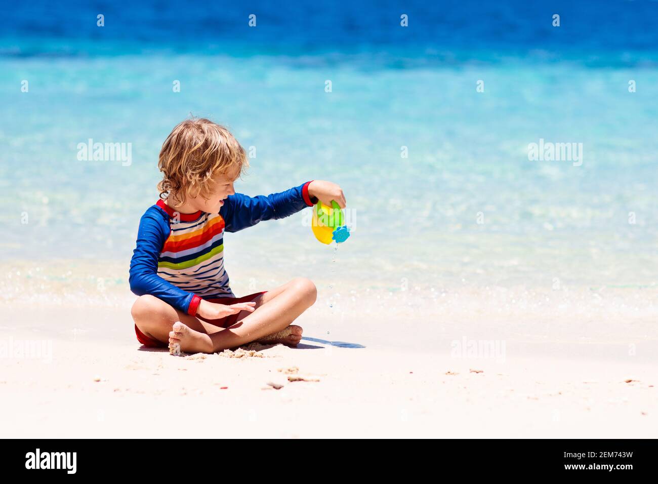 Kids playing on tropical beach. Children swim and play at sea on summer ...