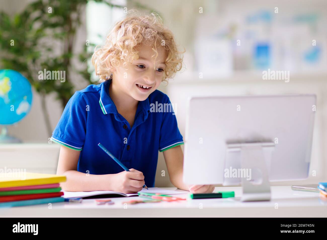 Online remote learning. School kids with computer having video ...