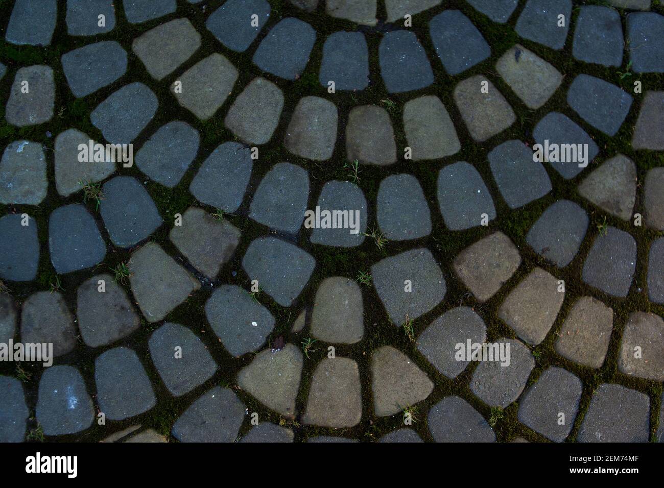 Texture of stone paving stones. Cobblestone arched pavement road at the ...