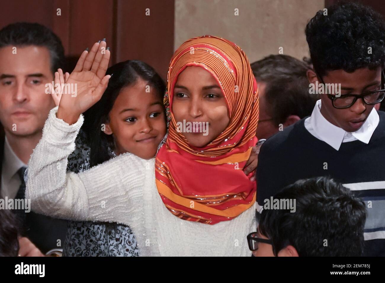 Rep. Ilhan Omar stands with her three children as she is sworn in on ...