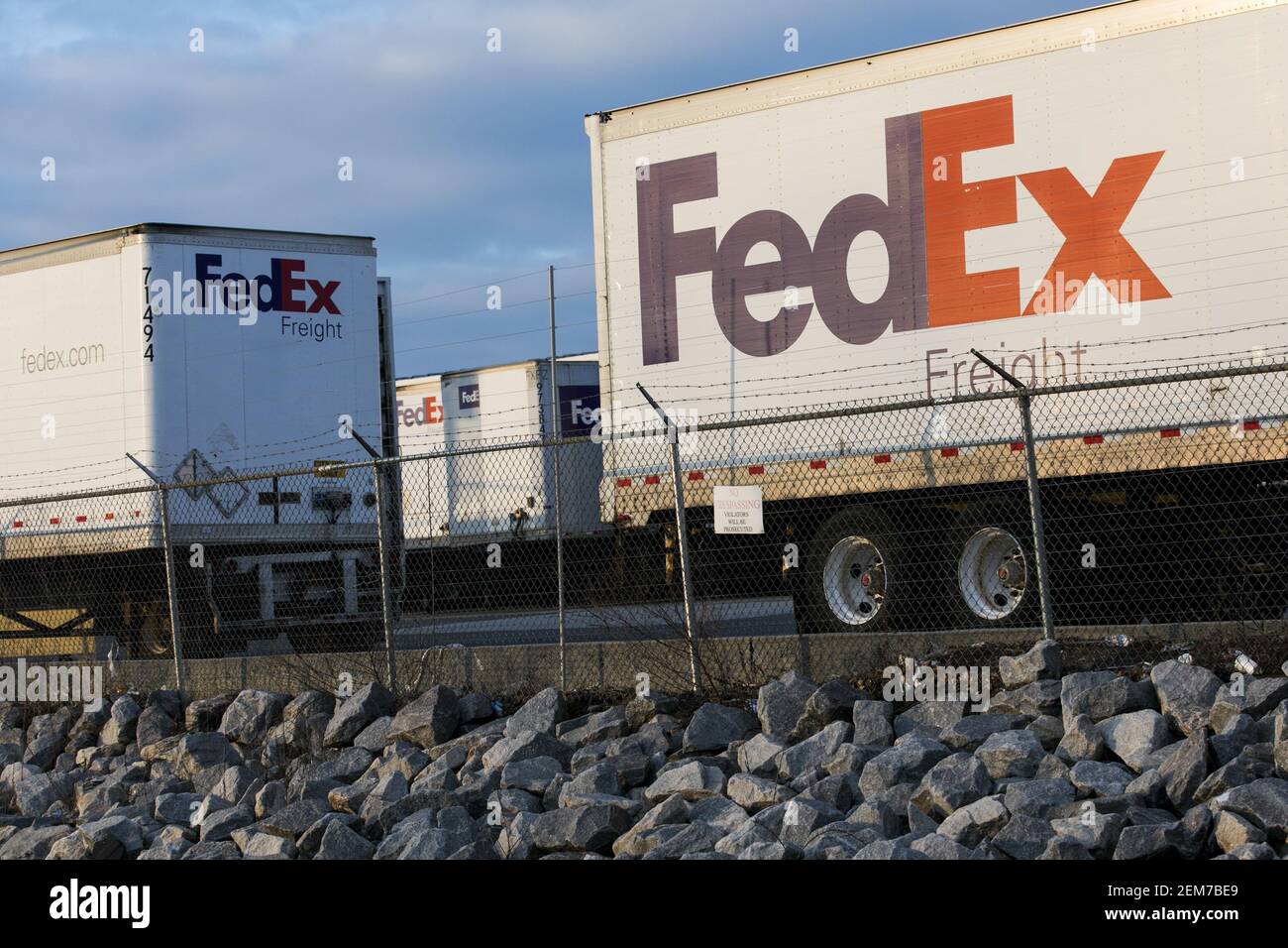 Logo signs on a row of FedEx Freight trailers at a distribution center ...