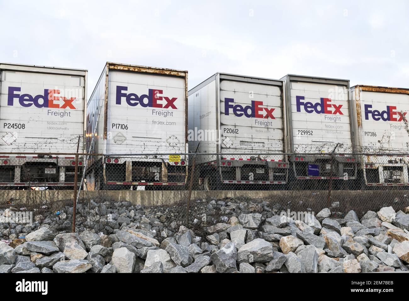Logo signs on a row of FedEx Freight trailers at a distribution center ...