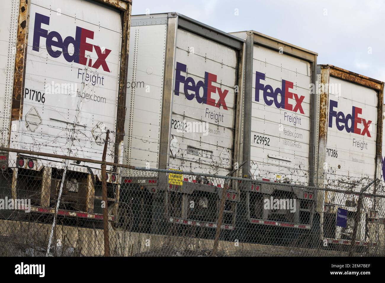 Logo signs on a row of FedEx Freight trailers at a distribution center ...