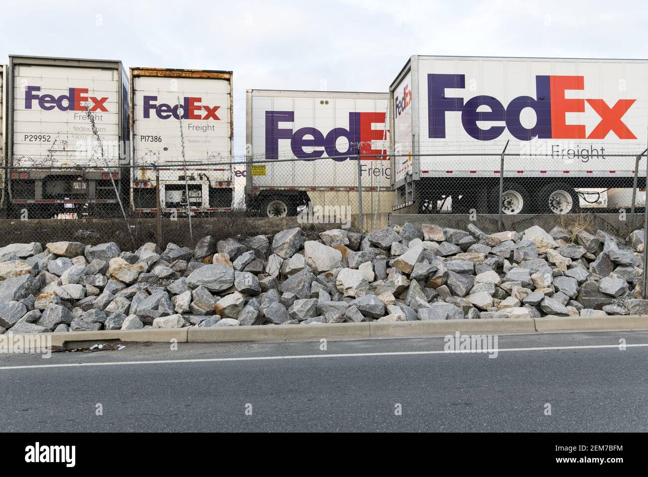 Logo signs on a row of FedEx Freight trailers at a distribution center ...