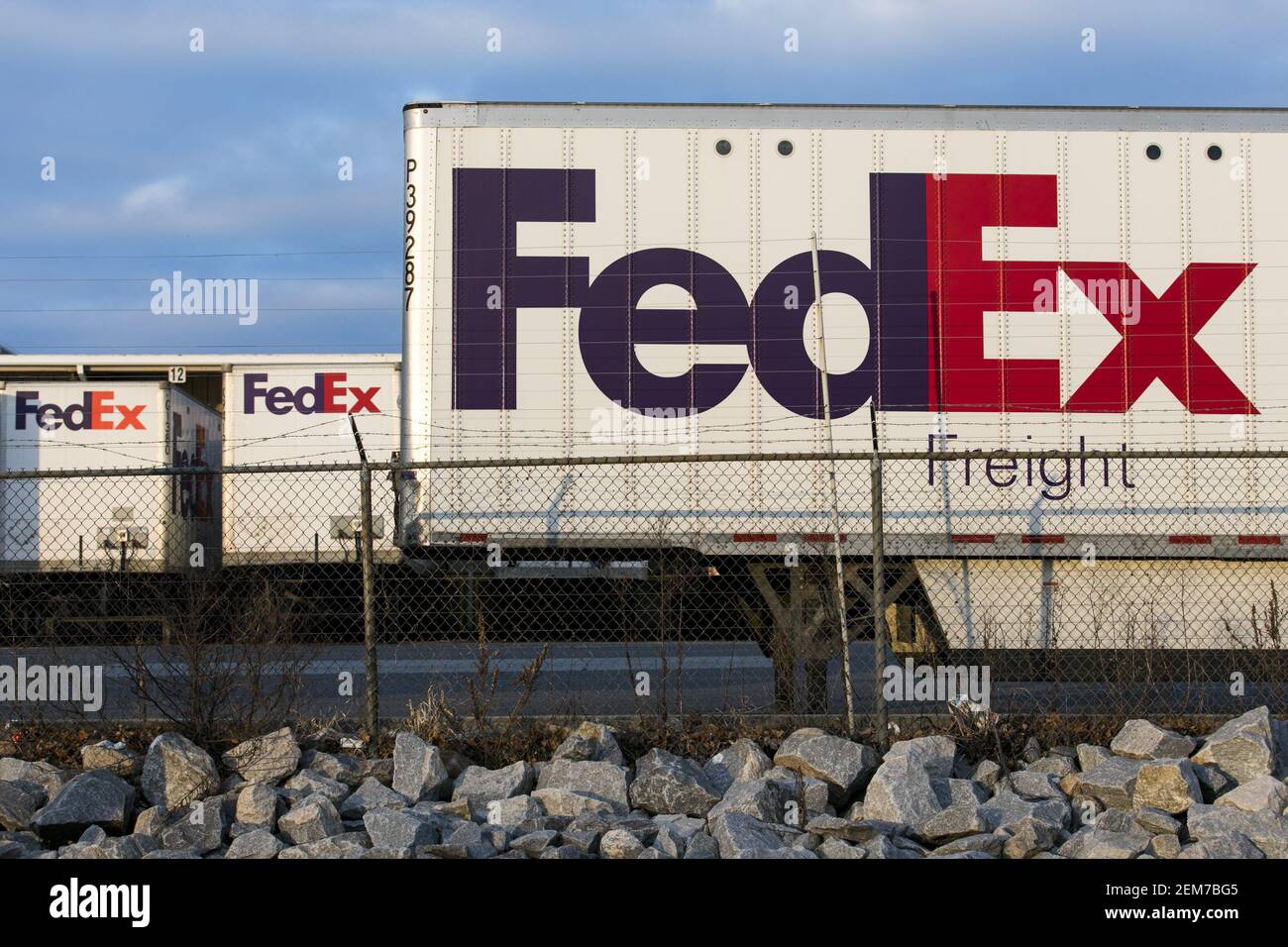 Logo signs on a row of FedEx Freight trailers at a distribution center ...