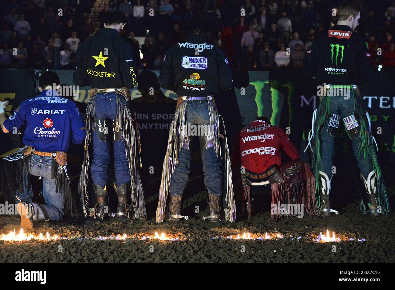 Professional bull riders line up for the singing of the U.S. National ...