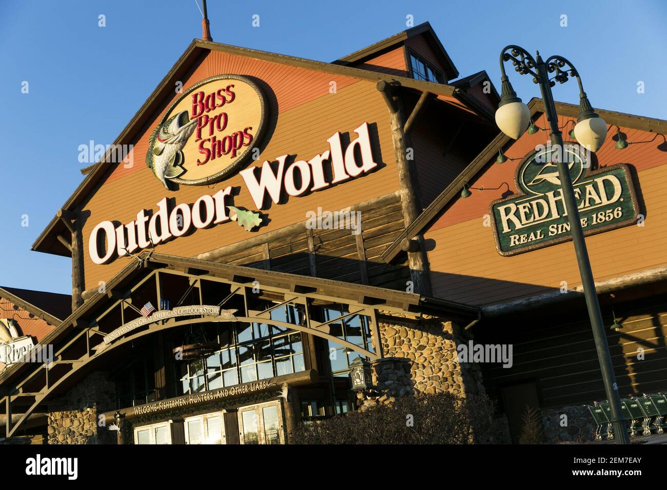 A logo sign outside of a Bass Pro Shops Outdoor World retail store in ...