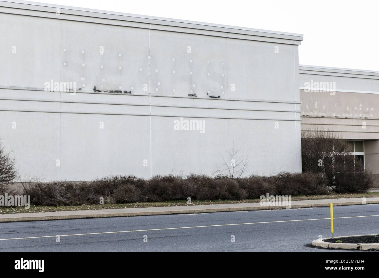 The outline of a logo sign at a closed Sears retail store in ...