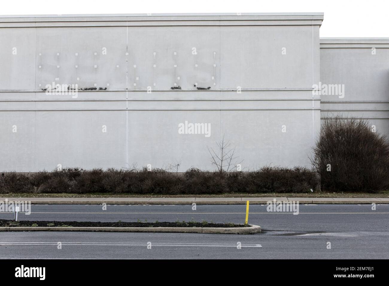 The outline of a logo sign at a closed Sears retail store in ...