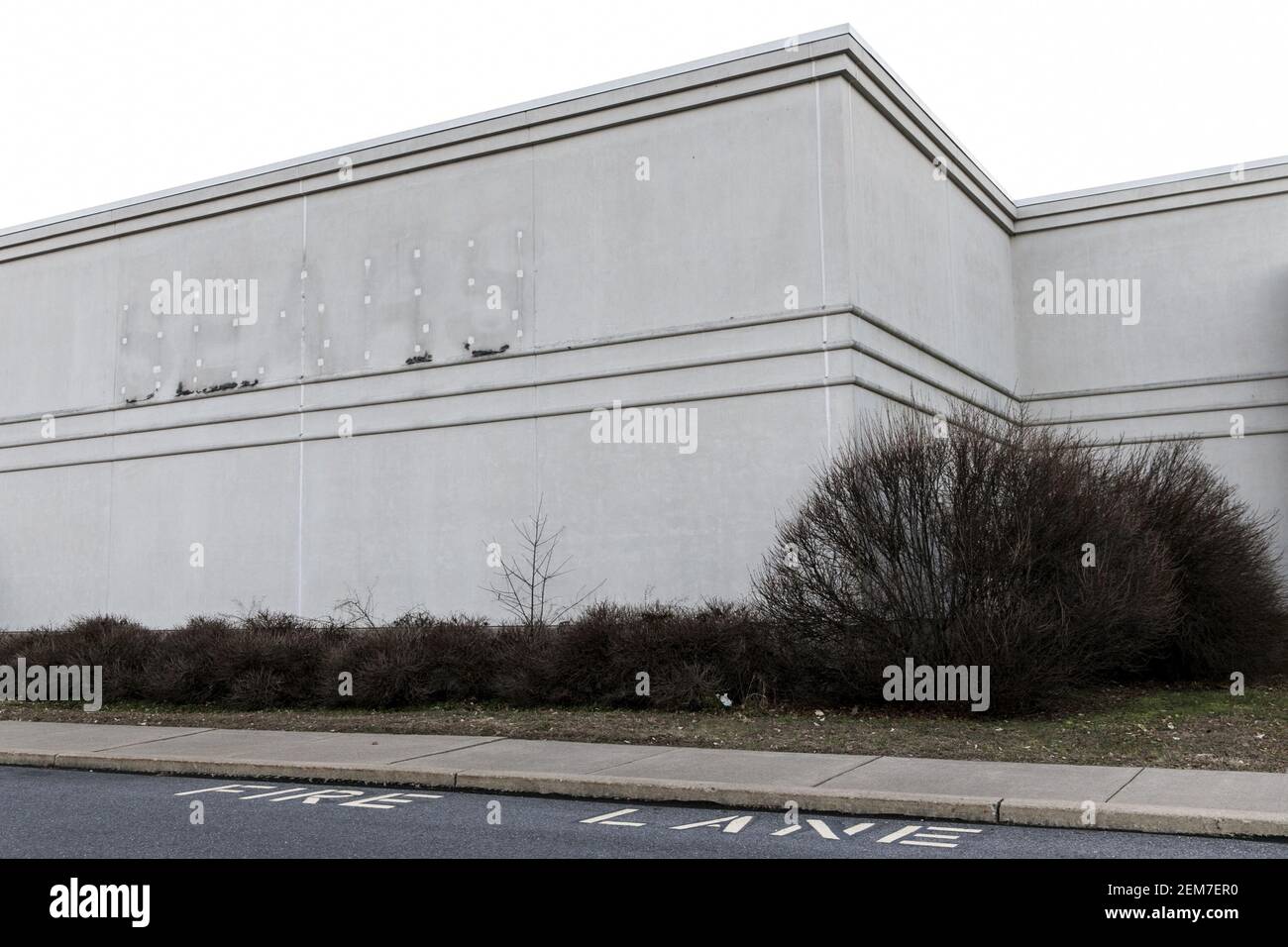 The outline of a logo sign at a closed Sears retail store in ...